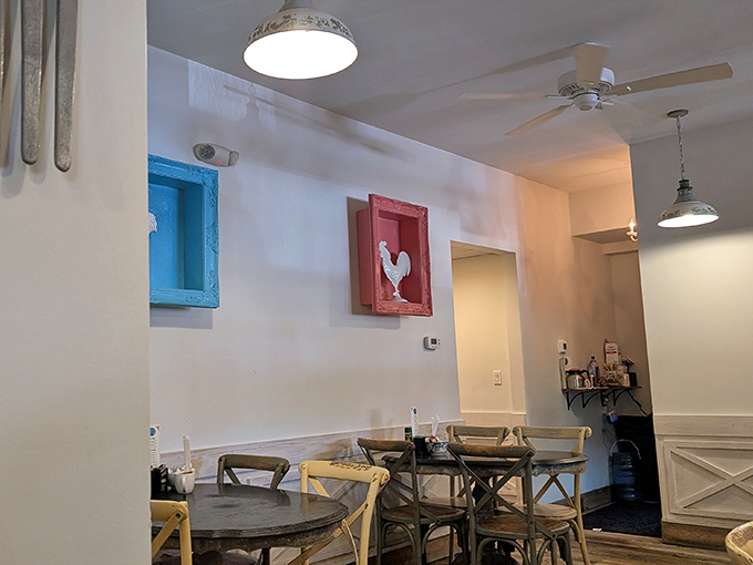 Coastal chic meets homey comfort with that adorable rooster painting standing guard over your breakfast dreams. The ceiling fans ensure your pancakes are the only thing that'll make you sweat.