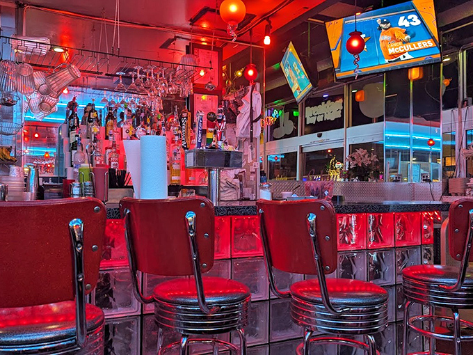 Step inside and the red neon glow transforms ordinary dining into a space-age adventure. Those counter stools have supported hungry earthlings for years.