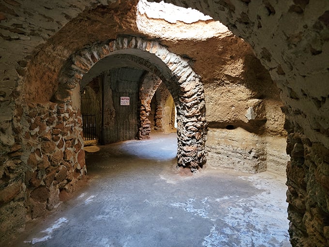 Roman-inspired arches guide visitors through cool, earthen corridors. The craftsmanship transforms what could have been a simple hole into an underground cathedral.