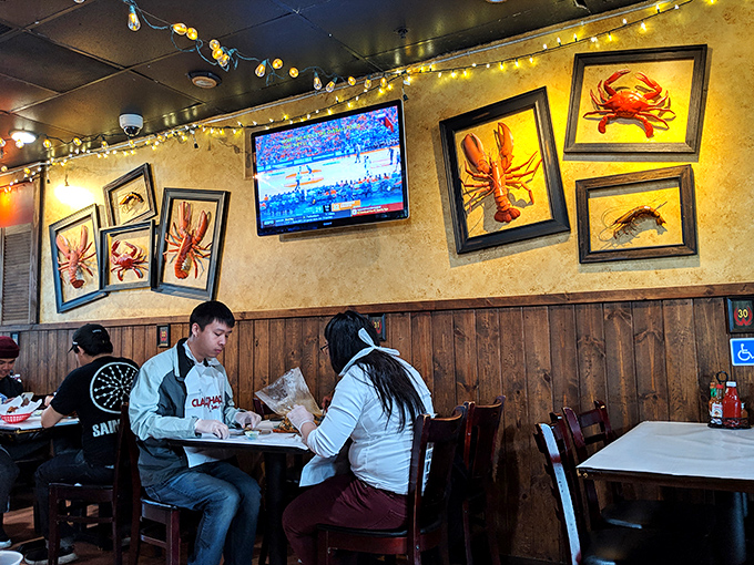 Wooden paneling, seafood artwork, and twinkling string lights create the perfect backdrop for crustacean communion. Casual comfort meets oceanic inspiration.