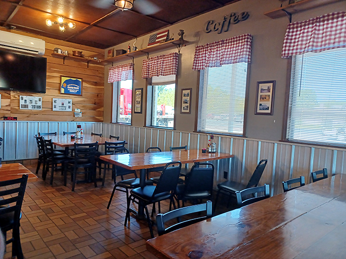 Red checkered curtains, wooden paneling, and simple tables create that perfect diner atmosphere where conversations flow as freely as the coffee.