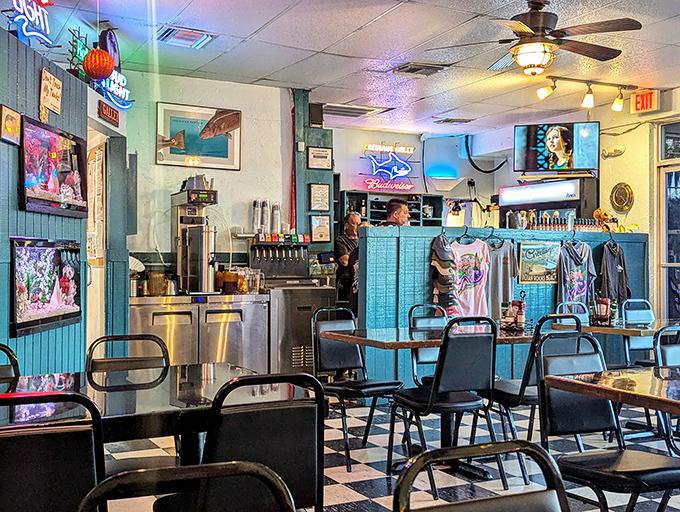 Step into seafood nirvana where coastal blue walls, neon signs, and no-nonsense tables create the perfect backdrop for the serious business of lobster consumption.
