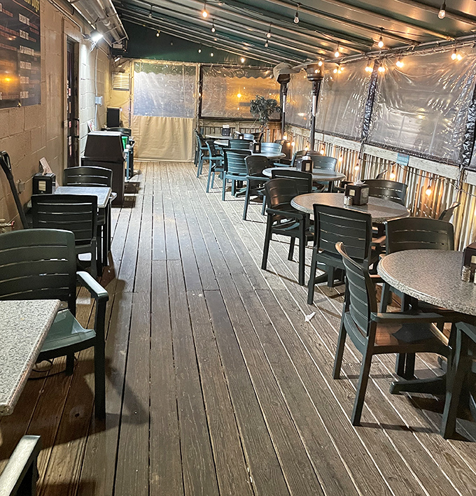 String lights and wooden decking create a cozy outdoor dining space where summer evenings are measured in empty hot dog baskets and satisfied smiles.