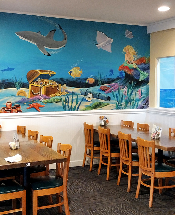 Mermaids, sharks, and hidden treasure adorn the walls, promising underwater delights that actually deliver on your plate.