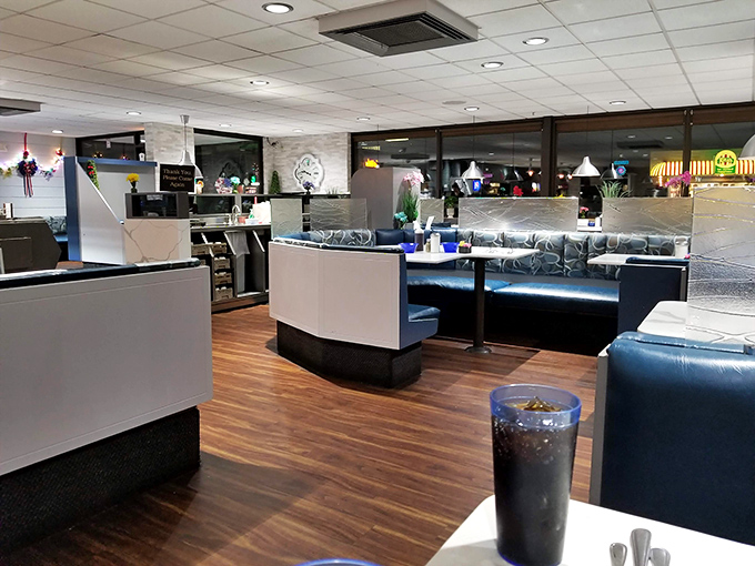Blue booths and warm lighting create the perfect backdrop for life's important discussions: politics, weather, and whether to order dessert.