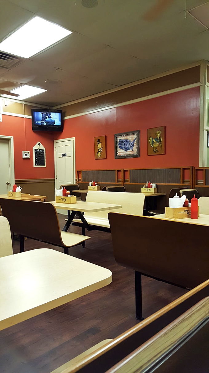 Simple booths, orange walls, and zero pretension—this is where barbecue speaks louder than interior design ever could.