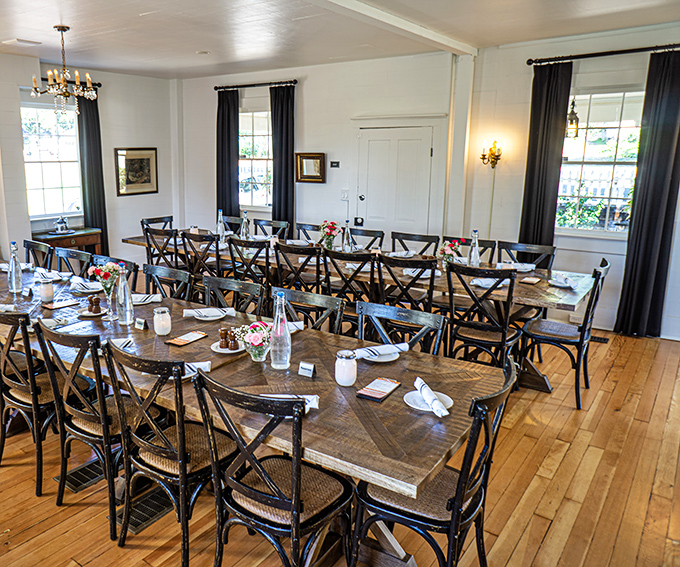 Rustic wooden tables and cross-back chairs create the perfect setting for both family celebrations and intimate dinners. Grandma would approve.