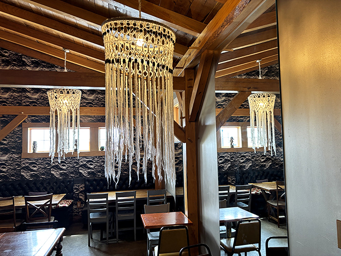 Macram&eacute; chandeliers dance above wooden tables, creating an atmosphere where British pub meets Indiana charm. Cozy doesn't begin to describe it.
