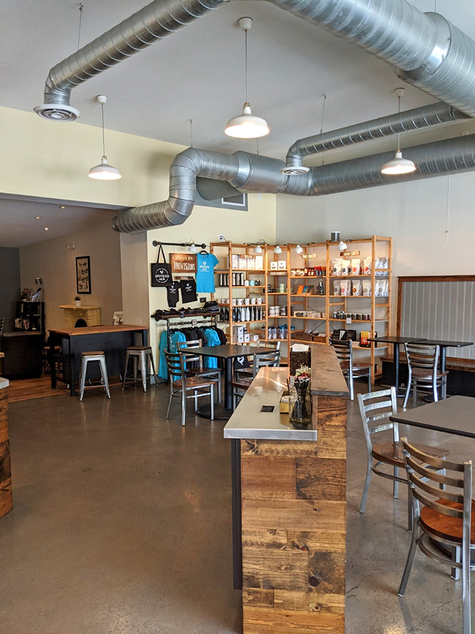 Industrial meets cozy in this thoughtfully designed space where exposed ductwork plays nicely with reclaimed wood counters and shelves lined with local goods.