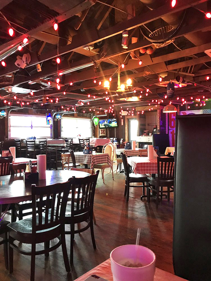 String lights crisscross the ceiling like a constellation of culinary stars, illuminating red-checkered tables where fried chicken dreams come true. 
