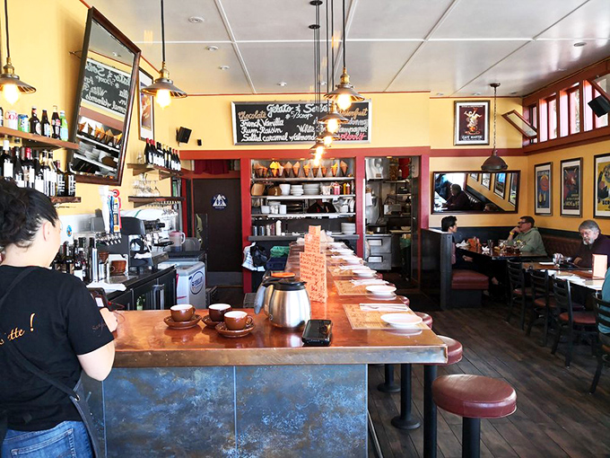 Inside, yellow walls and pendant lighting create that magical bistro atmosphere where strangers become friends over shared food recommendations.