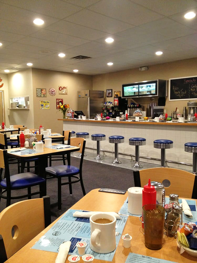 Classic blue counter stools and simple tables create that "everybody knows your order" atmosphere where coffee refills arrive before you ask.