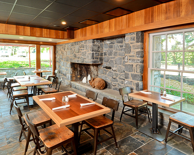 Stone walls and wooden accents create a rustic sanctuary where BBQ is treated with the reverence it deserves. That fireplace isn't just for show, folks.