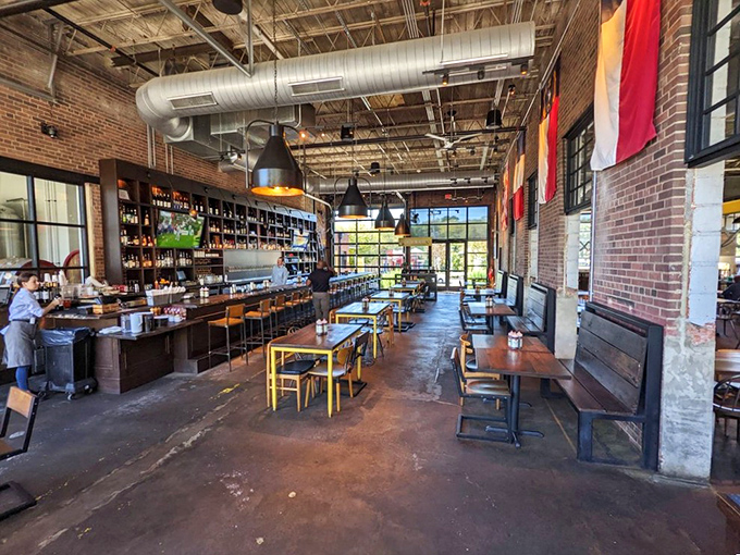 Industrial chic meets Southern comfort inside Noble Smoke, where exposed brick and ductwork create the perfect backdrop for serious barbecue business.