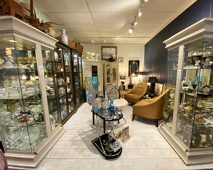 Crystal cases flank a cozy seating area, inviting you to imagine these elegant pieces gracing your own Florida home.
