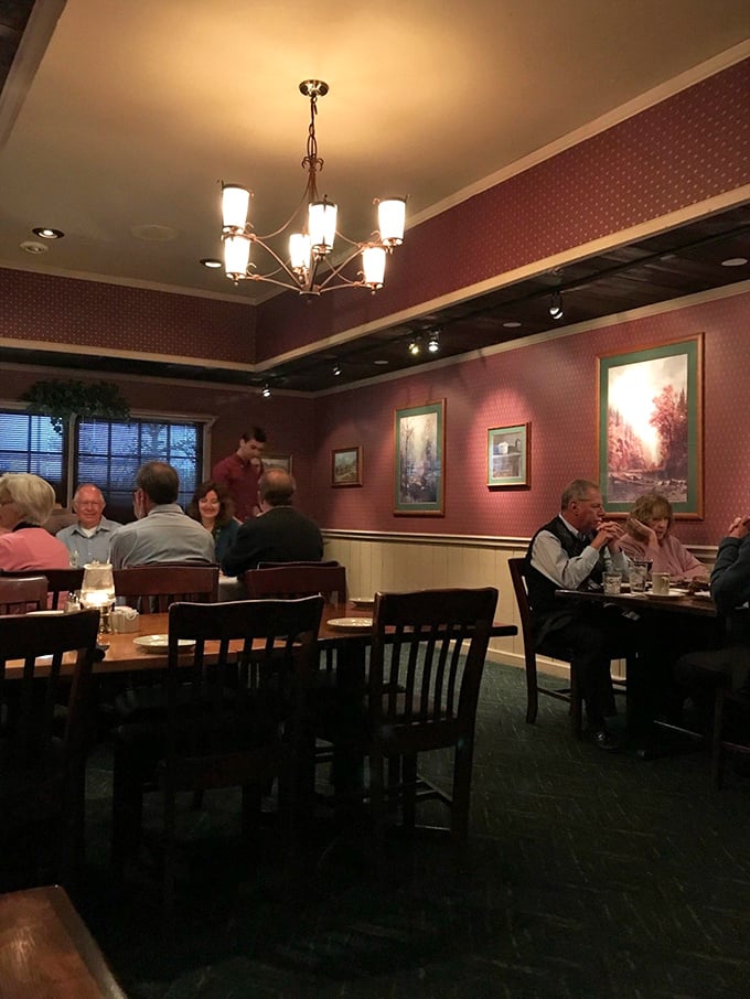 Burgundy walls, elegant lighting, and comfortable seating create the perfect backdrop for the meat-centric drama about to unfold on your plate.