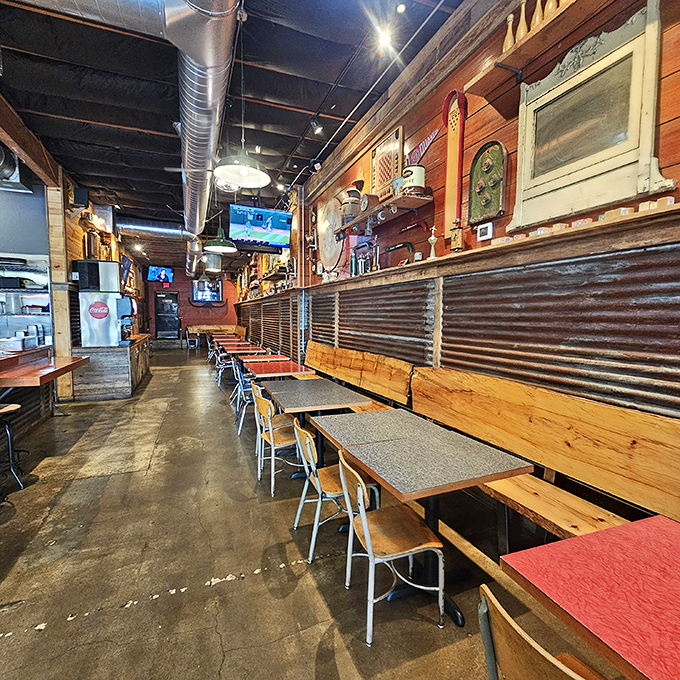 Industrial chic meets comfort food haven. The exposed ductwork and wooden tables create the perfect backdrop for what's about to become your new favorite chicken obsession.