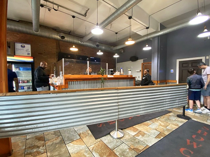 Industrial chic meets barbecue functionality at the ordering counter, where corrugated metal and exposed ductwork set the stage for serious eating.