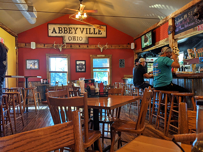Inside, rustic wooden charm meets small-town hospitality. The "Abbeyville, Ohio" sign and mounted deer heads tell you this place takes both local pride and meat seriously.