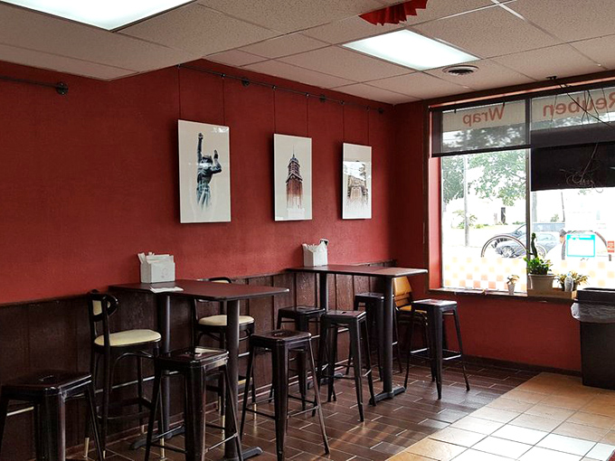 Red walls and simple seating create the perfect backdrop for sandwich artistry. No distractions here&mdash;just you and your imminent Reuben rendezvous.