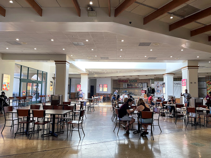 The food court: where shopping marathoners refuel before their next sprint through the sales racks. Strategic carb-loading at its finest.