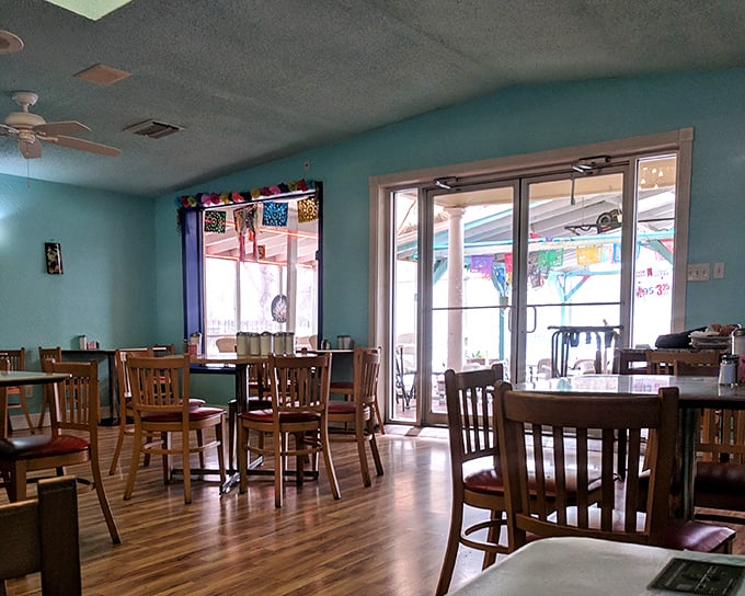 Turquoise walls and wooden chairs create that perfect "abuela's dining room" vibe &ndash; unpretentious, welcoming, and promising something delicious is about to happen.
