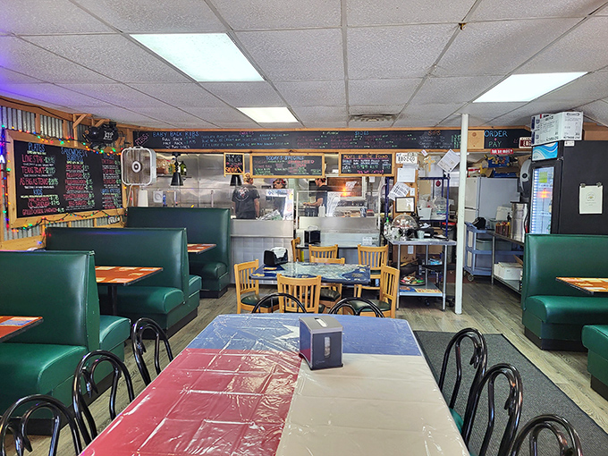 Step inside where fluorescent lights illuminate culinary dreams and green booths hold countless satisfied customers.