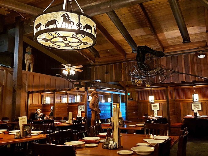 Step inside and you're transported to the Old West, where wagon wheel chandeliers cast a warm glow over wooden booths. John Wayne would feel right at home.