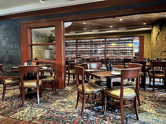 Wine bottles line the wall like soldiers guarding flavor, while rich wood and patterned carpet create the perfect backdrop for carnivorous adventures.