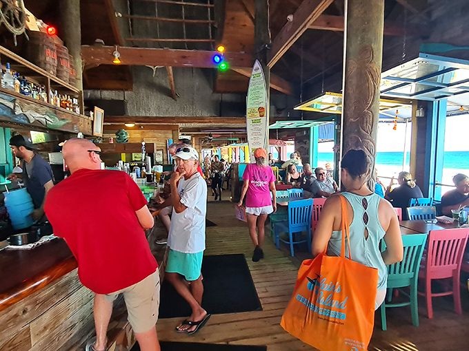 Inside, the restaurant buzzes with beach-casual energy. Surfboards hang from rafters while colorful chairs invite you to settle in for seafood that's worth any wait. 