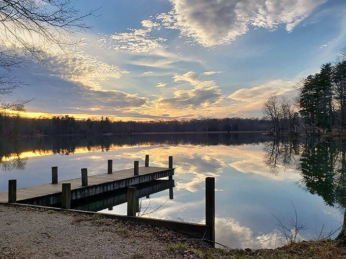 Sunrise or sunset? Either way, this wooden dock invites contemplation as the sky performs its daily masterpiece across the glassy waters.