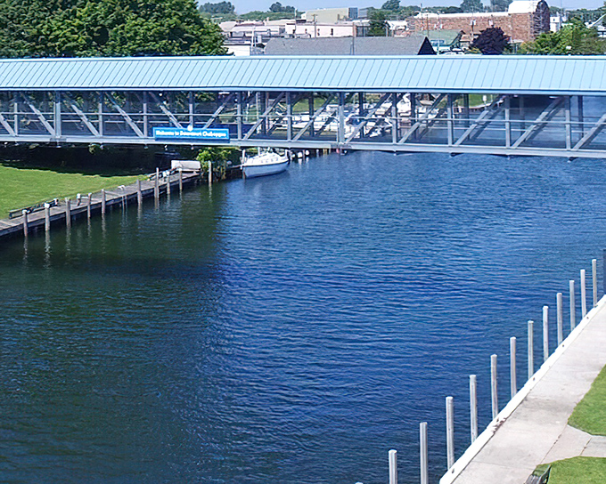 The pedestrian footbridge spans Cheboygan's liquid Main Street, offering views that would cost a fortune elsewhere but here are just part of daily life.