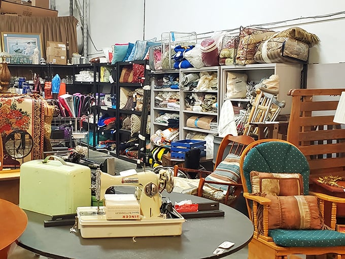 Organized chaos at its finest! Vintage sewing machines, colorful fabrics, and wooden furniture create a thrifter's playground where one person's castoffs become another's treasures.