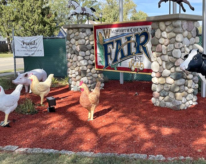The historic Walworth County Fairgrounds welcomes visitors with its charming entrance, complete with farm animal statues that seem to say, "Come on in, the bargains are fine!"