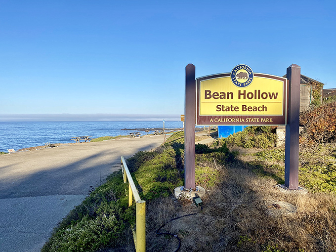 The unassuming entrance to paradise. This modest sign marks the boundary between everyday life and coastal magic.