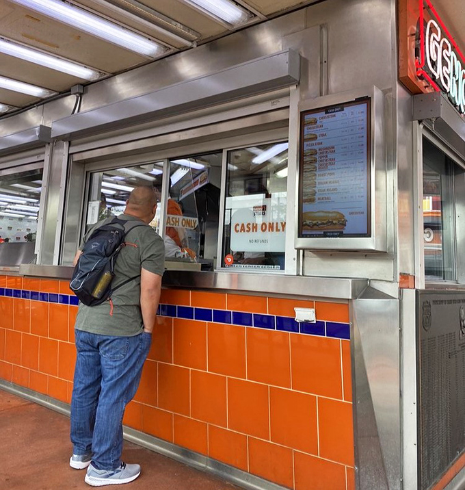 The moment of truth arrives at the ordering window. Remember: "Whiz wit" means with cheese and onions, "witout" means you're missing out.