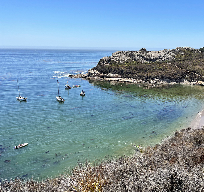 Sailboats dot the crystalline waters like daydreams, proving that sometimes the best vacation spots are in your own backyard.