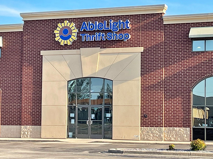 AbleLight's sunny logo brightens the brick facade like a thrifter's North Star. Guiding bargain hunters to fashion finds and furniture treasures.