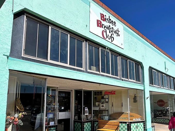 The turquoise beacon of Bisbee Breakfast Club stands out against the desert sky, promising morning delights worth the drive.