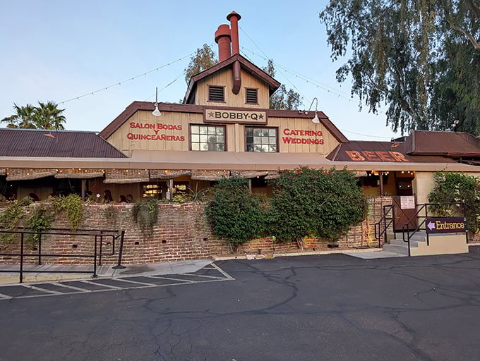 Bobby-Q's historic building wrapped in vibrant bougainvillea &ndash; where brick, blooms, and barbecue create a feast for all senses.