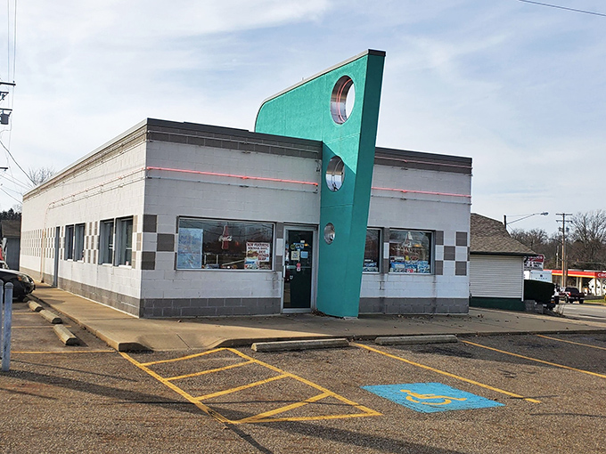 Doug's teal fin-shaped sign stands prouder than a peacock, beckoning burger lovers with its 1950s architectural swagger.