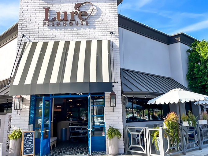 Lure Fish House's crisp white exterior says "vacation mode activated." The striped awning hints at nautical delights waiting inside this Scottsdale hotspot.