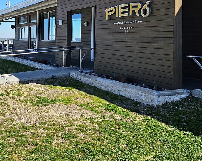Pier 6's modern coastal design welcomes seafood lovers to San Leon. Clean lines and golden lettering promise sophisticated Gulf flavors.