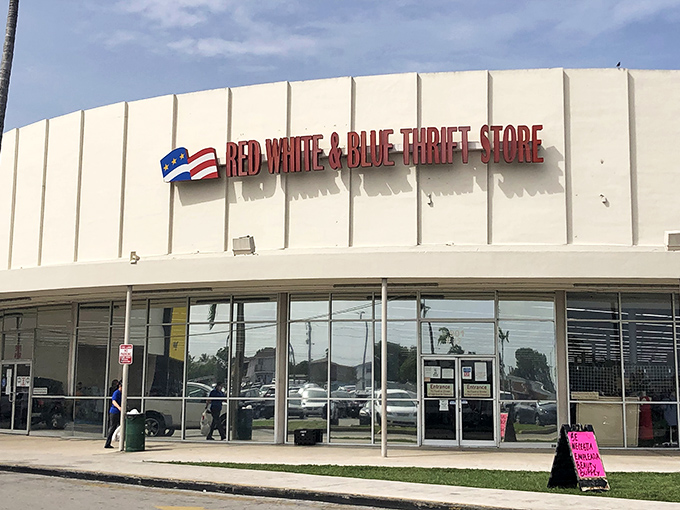 Red White & Blue Thrift Store's patriotic signage stands out against the Florida sky. A bargain hunter's paradise hiding in plain sight.