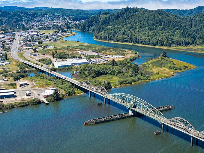 Reedsport's iconic bridge spans the Umpqua River like a steel rainbow, connecting forest to shore in perfect harmony.