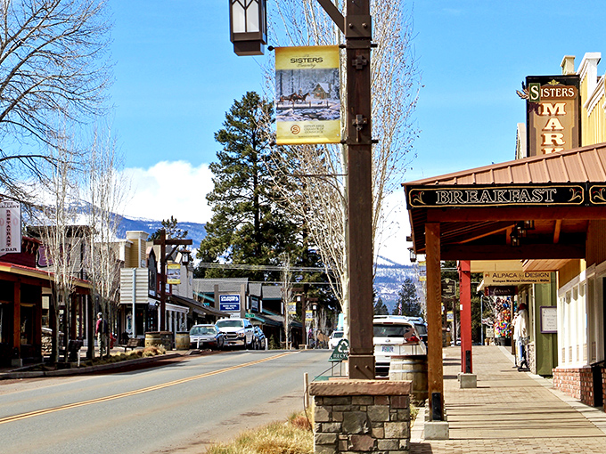 The wooden storefronts of Sisters stand against a backdrop of snow-capped peaks, creating a postcard-perfect mountain town.