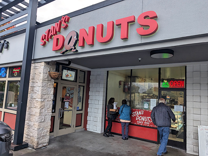 Stan's Donuts beckons hungry customers with its classic red signage. A donut sanctuary where time stands still and calories don't count.