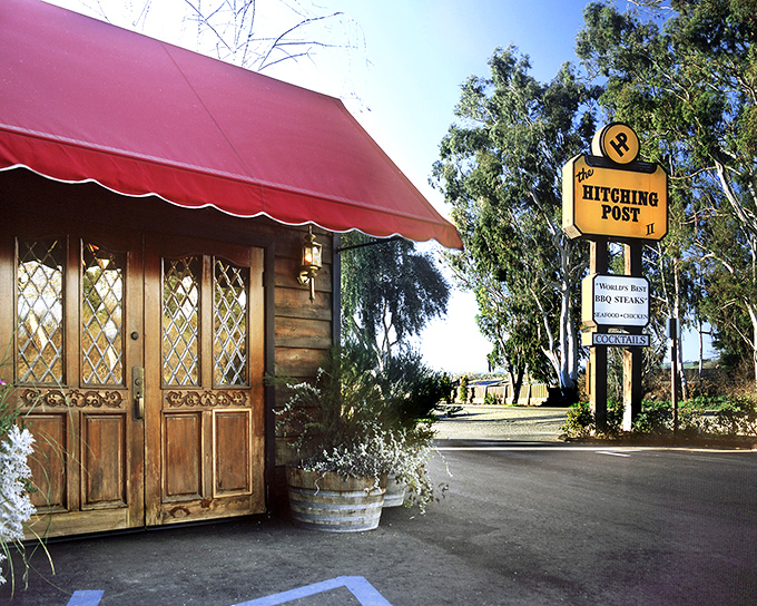 The Hitching Post's red awning signals you've arrived at steak paradise. This unassuming entrance leads to oak-grilled magic that made "Sideways" fans swoon.