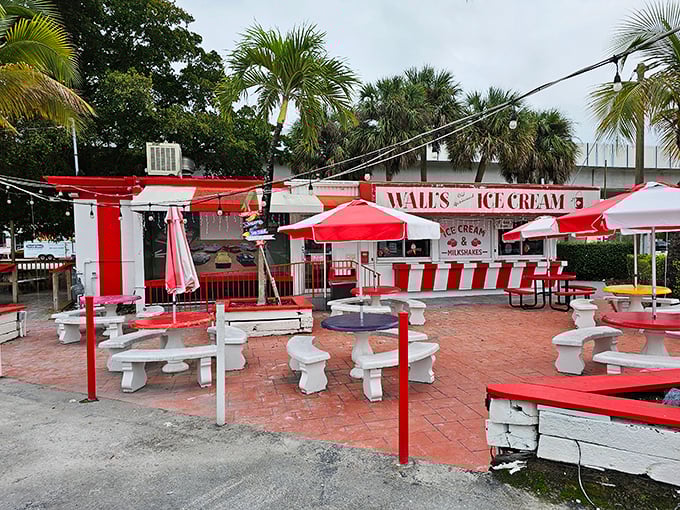 Wall's Old Fashioned Ice Cream's outdoor paradise – where palm trees, red umbrellas, and creamy scoops create the perfect Florida moment.