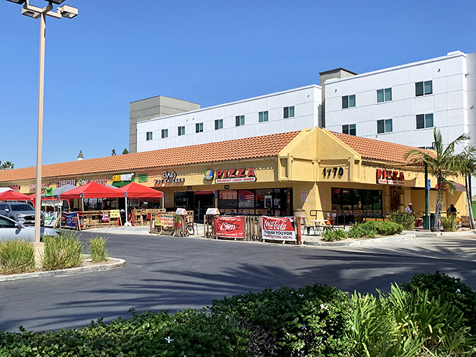 Sun-drenched and welcoming, this yellow-awninged pizza haven stands ready to rescue families from overpriced theme park food fatigue.